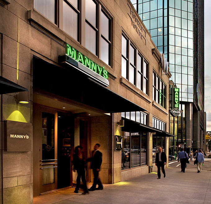 Manny's iconic green neon sign glows like a beacon for carnivores, promising meaty treasures within this Minneapolis landmark.