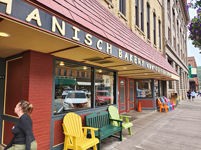 That cheerful red awning and those rainbow Adirondack chairs are basically screaming "sit down and eat something delicious," and honestly, who are you to argue with furniture?