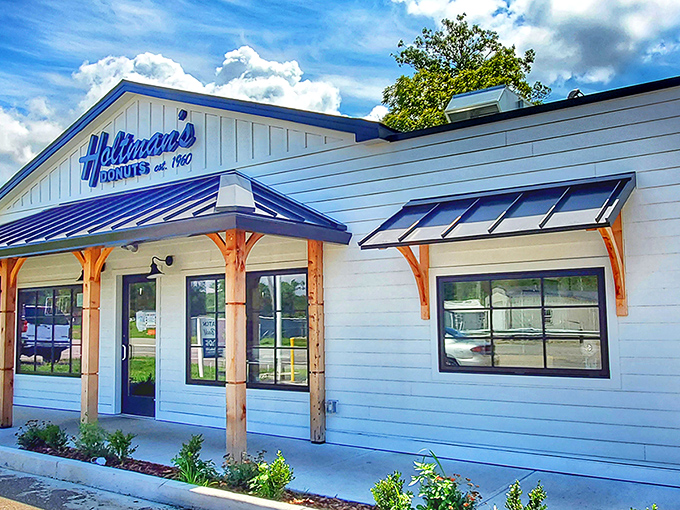 Holtman's Donut Shop: A charming white building with blue trim that promises sweet salvation for donut lovers &ndash; like a lighthouse guiding sugar-seekers home.