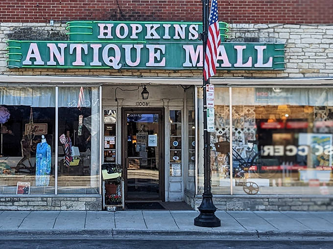 The iconic green sign of Hopkins Antique Mall beckons treasure hunters with promises of vintage wonders hiding just beyond those doors.