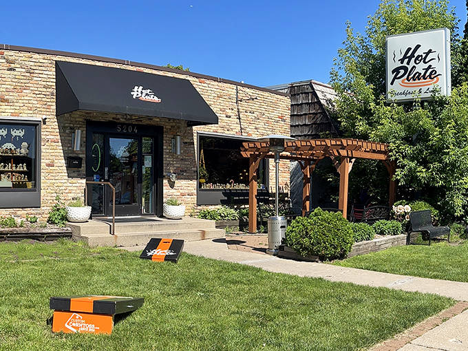 The unassuming brick exterior of Hot Plate belies the whimsical wonderland waiting inside. That wooden pergola practically whispers, "Come on in, the nostalgia's fine!"