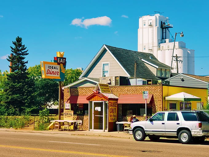 The iconic Ideal Diner exterior stands proudly against the Minneapolis skyline, its vintage sign beckoning hungry travelers like a breakfast lighthouse.