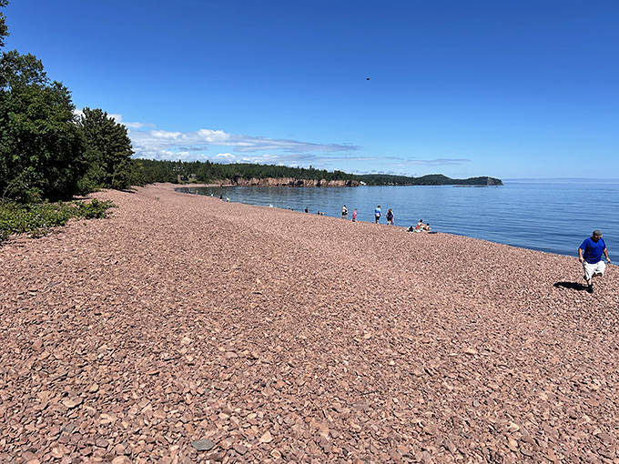 Iona's Beach stretches like a pink ribbon along Lake Superior's edge, where every pebble tells a geological love story.