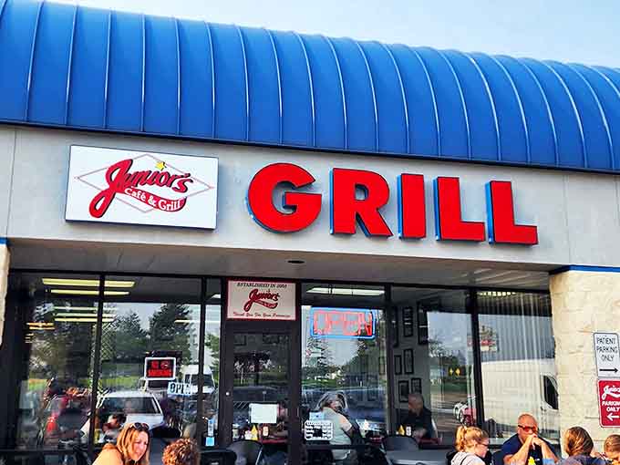 Junior's iconic blue-roofed exterior with its bold red GRILL sign stands as a beacon for comfort food seekers in Eagan, Minnesota.