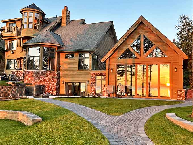 Sunset bathes Keweenaw Castle in golden light, its stone and timber facade glowing like a beacon above Lake Superior's shimmering waters.