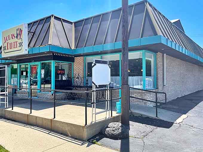 Lola's Diner stands proudly on Busse Highway, its distinctive teal trim and vintage signage beckoning hungry time-travelers from miles around.