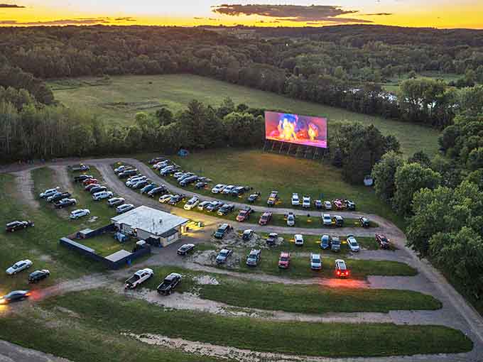 Twilight magic unfolds as cars gather beneath the massive screen, Wisconsin's countryside providing the perfect backdrop for cinematic escape.
