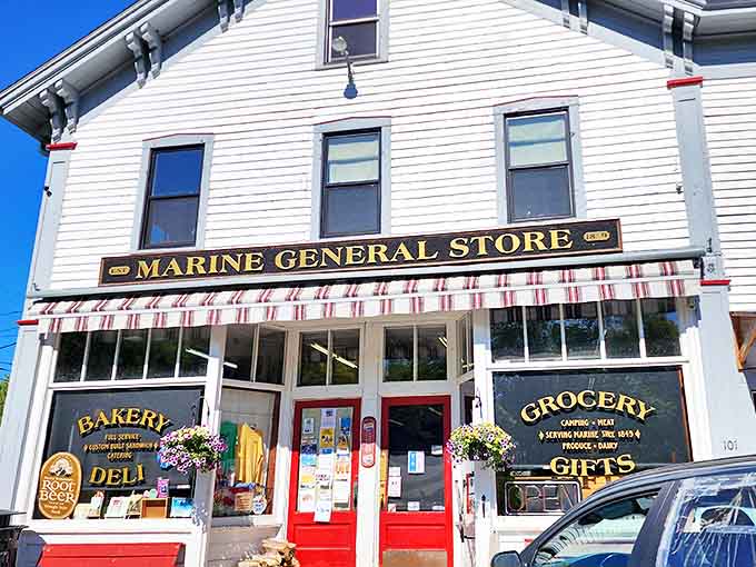 The classic white clapboard exterior with its iconic red door stands as a beacon of community and commerce in Marine on St. Croix.