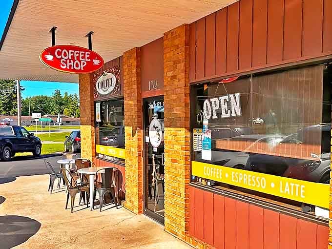 The welcoming brick facade of Michigan Coffee Co. beckons coffee lovers with its classic red sign &ndash; like a lighthouse for caffeine seekers in downtown Cadillac.
