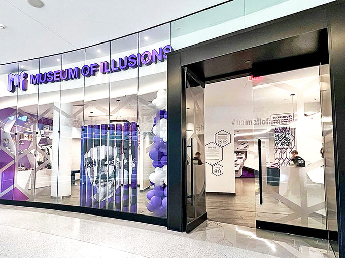 The purple-lit entrance to the Museum of Illusions beckons mall-goers with promises of reality-bending adventures inside. Your brain's workout begins here!