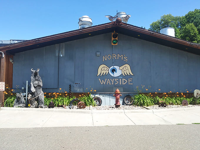 The blue-gray facade of Norm's Wayside stands proudly along Highway 55, its winged eyeball logo promising culinary adventures within.