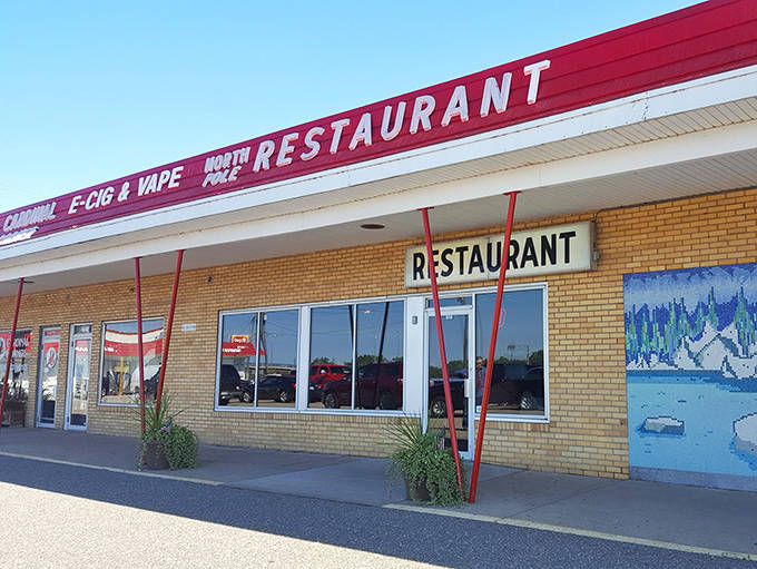 The iconic red-roofed North Pole Restaurant stands proudly in Newport, promising breakfast magic behind its unassuming brick facade.