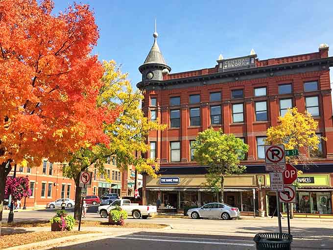 Northfield's historic downtown bursts with autumn colors, the iconic spire standing sentinel over Division Street's brick-fronted charm.