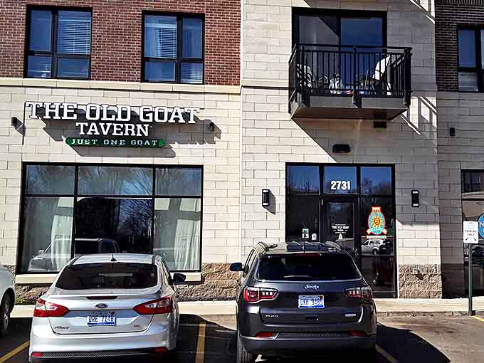 The unassuming facade of The Old Goat Tavern hides a burger paradise within, like finding a treasure chest disguised as a shoebox.