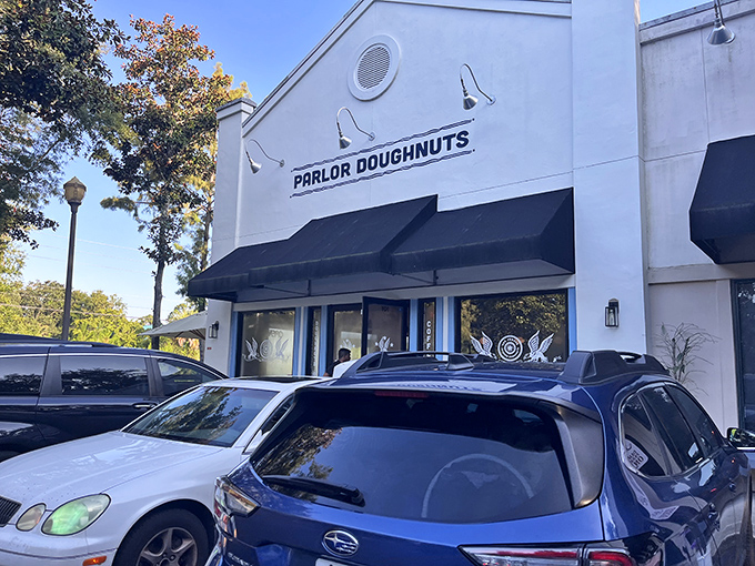Parlor Doughnuts' crisp white exterior with classic black awning promises sweet treasures within &ndash; like finding a jewelry box filled with edible gems.
