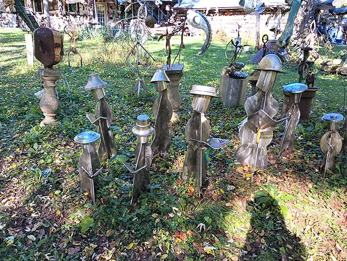 Metal sentinels stand guard in the grass, their recycled bodies catching autumn light like ancient guardians with modern souls.