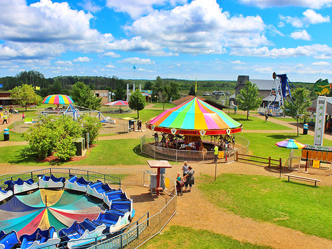 Paul Bunyan Land: Where rainbow-colored carousels and classic rides create a kaleidoscope of nostalgia under Minnesota's big blue sky.
