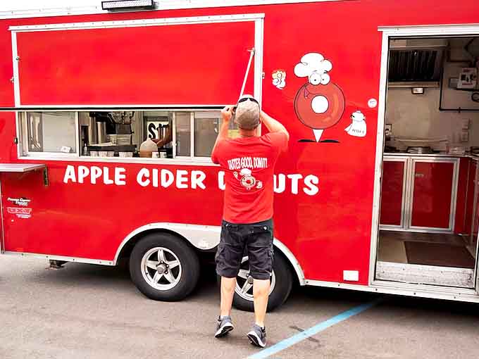 The bright red Petey's Donuts truck stands out like a beacon of sweetness, promising delicious treasures within its mobile kitchen.