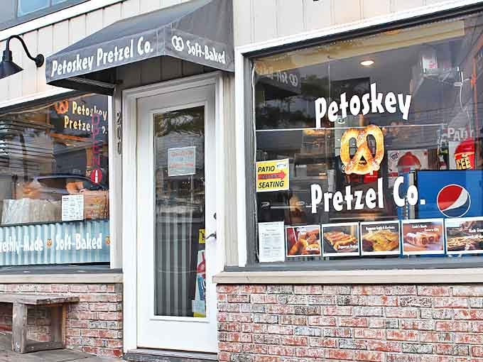 The inviting storefront of Petoskey Pretzel Co. beckons with promises of doughy delights, its brick-and-white facade housing Michigan's twisted treasures.