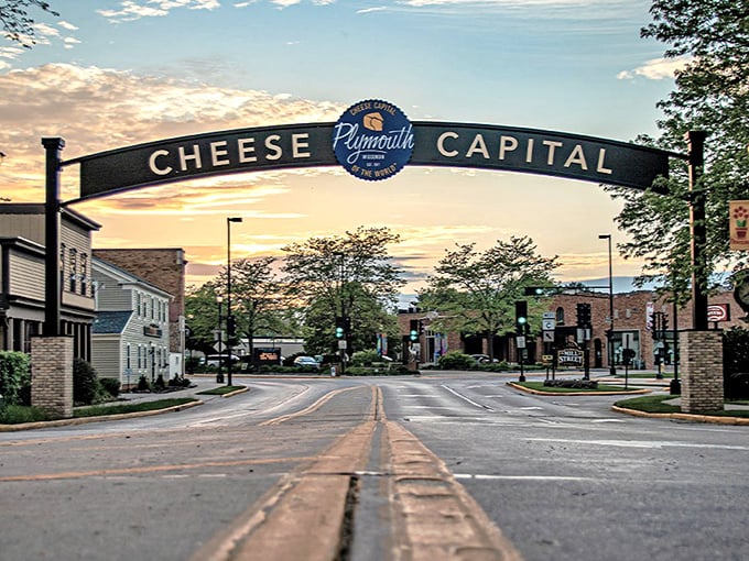 The iconic "Cheese Capital" arch welcomes visitors to Plymouth, where dairy dreams come true under Wisconsin skies.