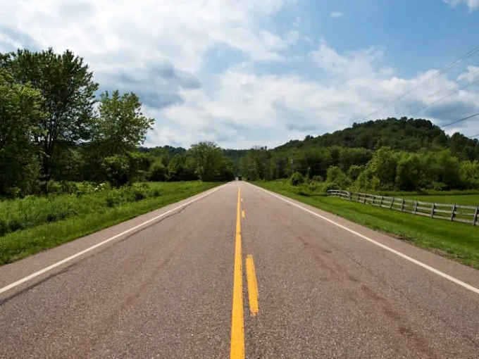 Where the yellow line stretches toward possibility and every curve whispers, "Slow down, the good stuff is just ahead."