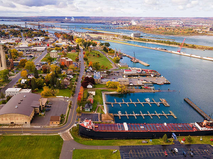 Sault Ste. Marie, MI: Where water meets wonder – this aerial view showcases Michigan's oldest city nestled perfectly between bustling waterways and historic neighborhoods.