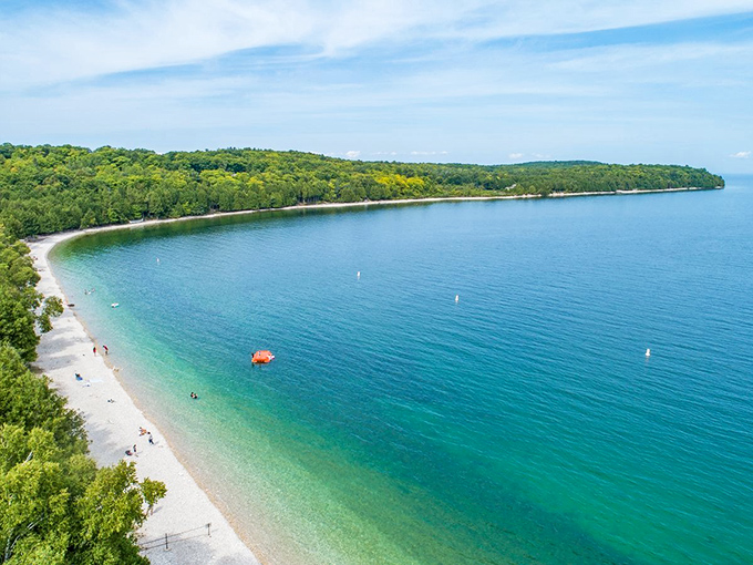 Paradise found: Where Caribbean-blue waters meet Wisconsin shores, creating a limestone beach that defies Midwestern expectations.