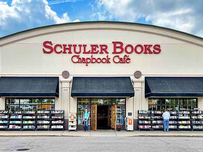 The welcoming facade of Schuler Books, where the red signage promises literary adventures and the Chapbook Caf&eacute; hints at delicious possibilities within.