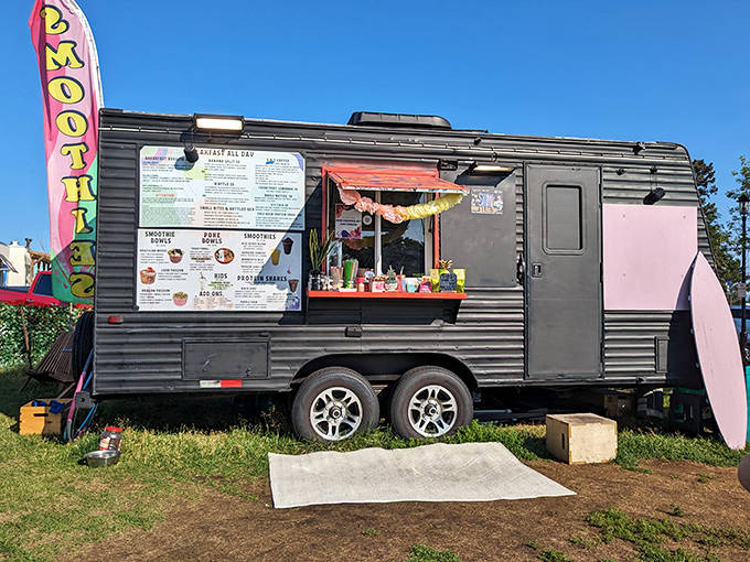 The sleek black Shook Smoothies food truck stands out with its vibrant signage, promising tropical flavors in the heart of Minnesota's North Shore.