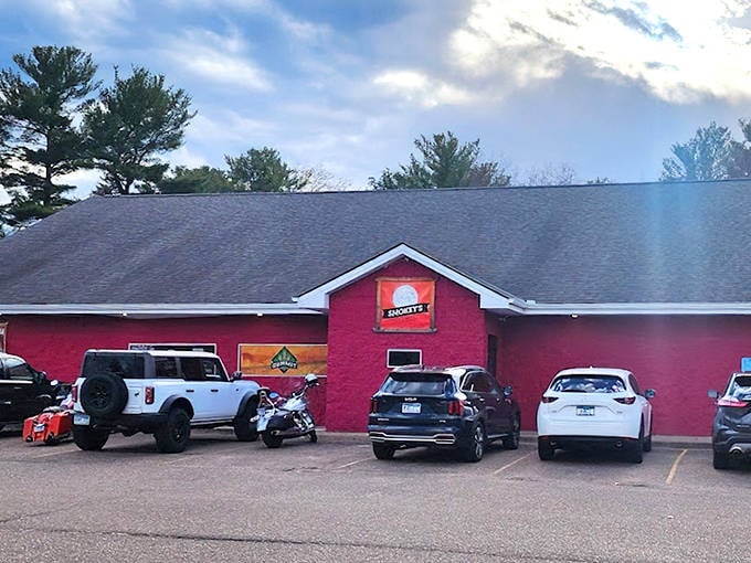 The bright red exterior of Smokey's Pub N' Grill stands out like a beacon for BBQ lovers, promising smoky delights within.
