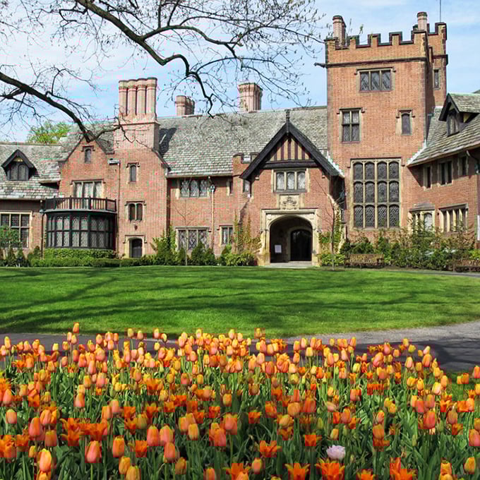 Stan Hywet's Tudor Revival fa&ccedil;ade stands proudly against Ohio skies, its brick and timber details whispering tales of Gilded Age opulence.