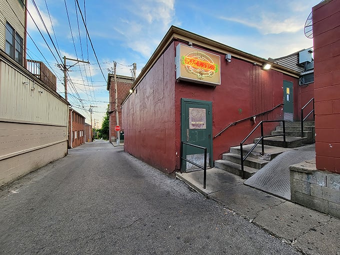 A humble red brick facade with a glowing sign&mdash;Oxford's best-kept secret hides in plain sight down this unassuming alley.