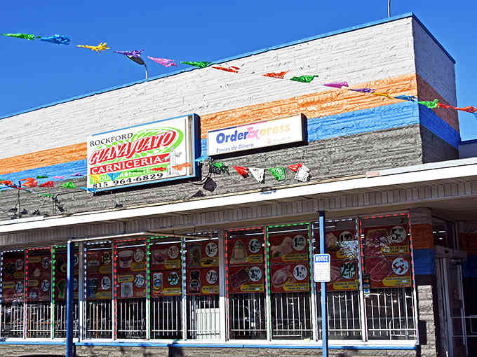 Colorful papel picado banners flutter above Guanajuato Rockford's modest exterior &ndash; a festive hint at the authentic Mexican experience waiting inside.
