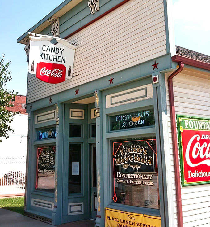 The cheerful yellow and green facade of The Candy Kitchen brightens Cumberland Street in Greenup, inviting passersby into its nostalgic embrace.