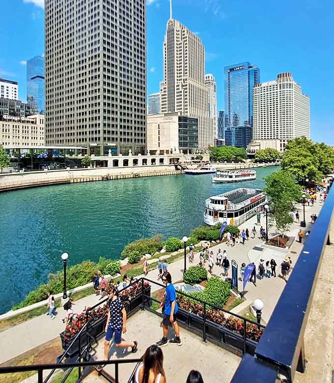 The Chicago Riverwalk: Where skyscrapers meet shoreline in a perfect urban harmony. Boats glide by as pedestrians soak in the architectural canyon views.