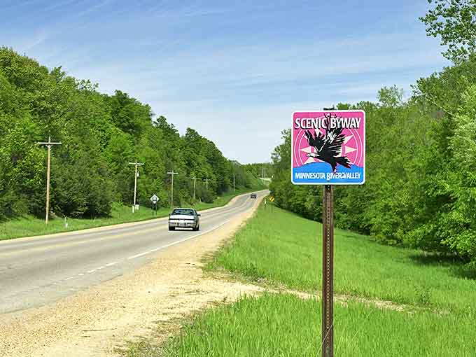 The iconic pink and blue Scenic Byway sign stands sentinel along the roadside, promising adventures that Minnesota's well-kept secret has in store.