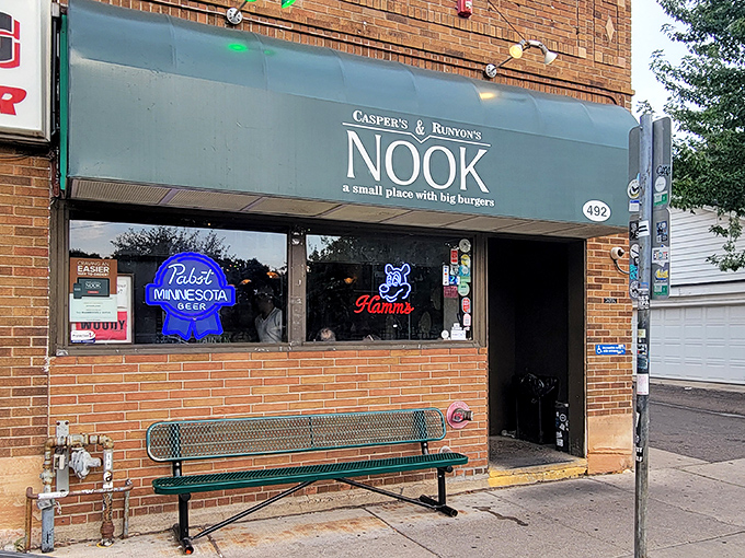 The unassuming exterior of Casper's & Runyon's Nook in St. Paul, where burger magic happens behind a modest green awning.