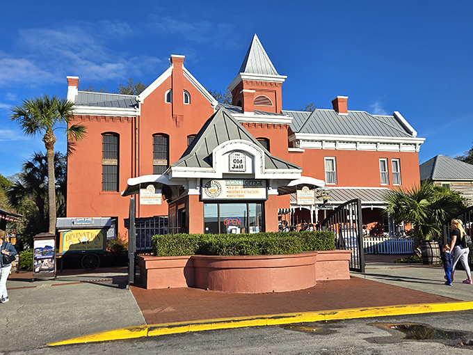 The striking coral-colored exterior of St. Augustine's Old Jail Museum beckons visitors with its deceptively charming Victorian architecture.