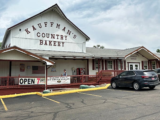 The iconic white barn facade of Kauffman's Country Bakery stands like a beacon of buttery hope for carb enthusiasts everywhere.