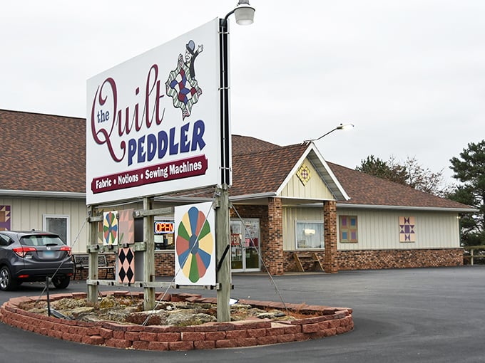 The welcoming facade of The Quilt Peddler stands proudly in Fennimore, Wisconsin, colorful quilt blocks hinting at the fabric wonderland within.
