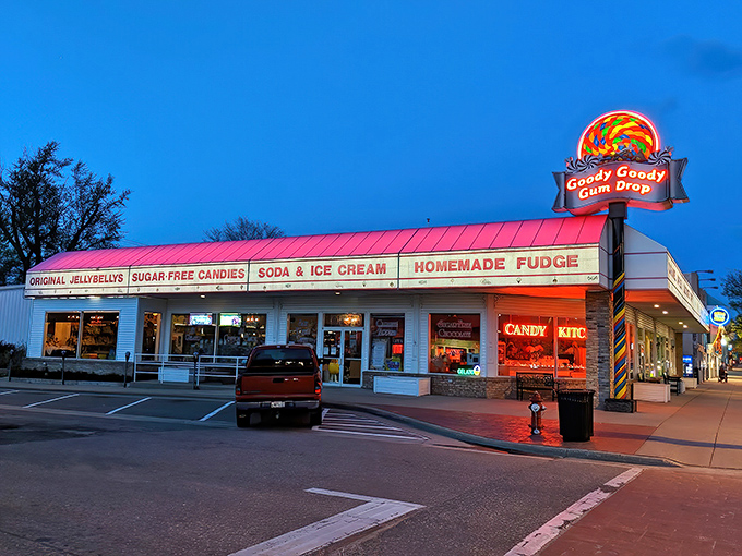 The iconic Goody Goody Gum Drop sign glows against the twilight sky, beckoning sugar enthusiasts like a beacon of sweet salvation.