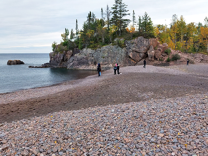 Nature's contradiction: Black Beach's dramatic shoreline where dark sands meet Lake Superior's crystal waters, creating Minnesota's most photogenic coastal paradox.