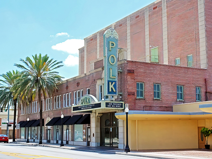 The iconic blue POLK sign stands tall against Florida's azure sky, a neon beacon calling culture-seekers to this Mediterranean-inspired time capsule.