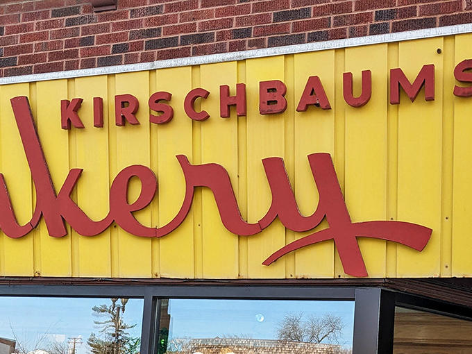The iconic yellow and red Kirschbaum's Bakery sign welcomes sweet-toothed visitors like a beacon of sugary hope on the horizon.