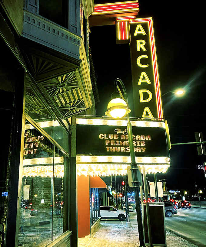 The iconic Arcada Theatre marquee glows like a beacon from the past, promising vintage thrills and modern indulgences upstairs.