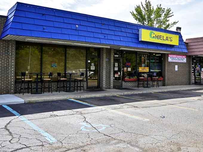 Chela's bright blue awning stands like a beacon of flavor on Liberty Street, promising authentic Mexican delights within these humble walls.