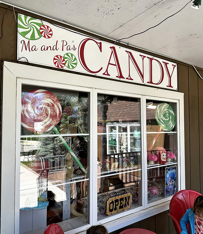 The charming storefront of Ma and Pa's Candy beckons with its vintage sign and peppermint swirl logo, promising sweet treasures within.