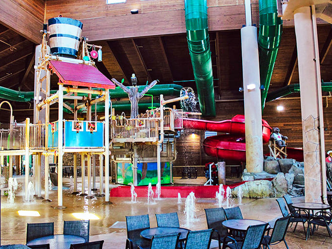 The heart of Three Bear Waterpark showcases a multi-level play structure where wooden beams meet colorful slides and that infamous tipping bucket awaits its next victims.