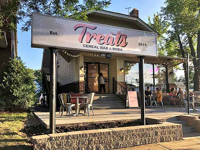The charming converted house exterior of Treats beckons with its pink sign, promising sugary adventures that'll make your inner child squeal with delight.