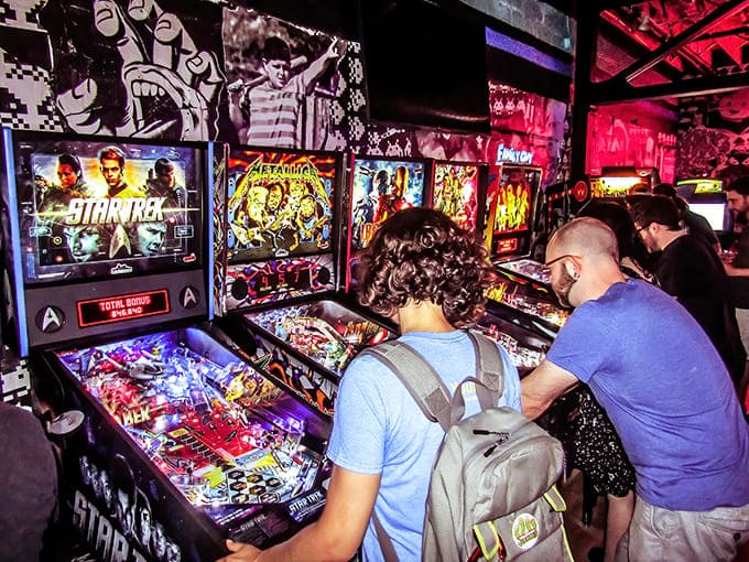 Up-Down Minneapolis: Where neon dreams and digital nostalgia collide &ndash; players battle it out on classic cabinets while Star Trek pinball beckons from the corner.